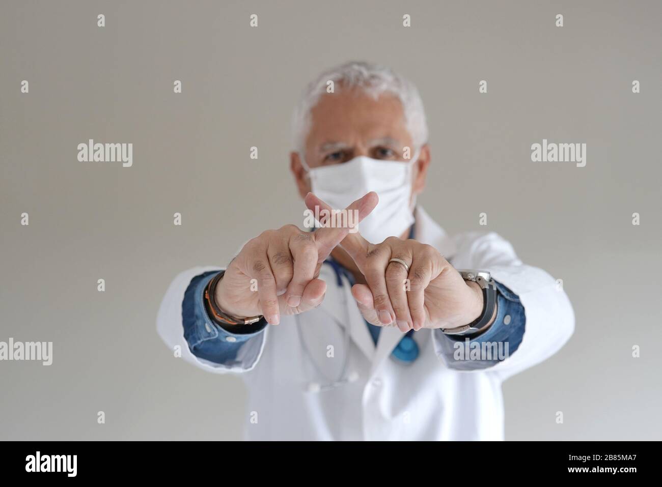 Doctor with protection mask stopping virus spreading, isolated Stock ...