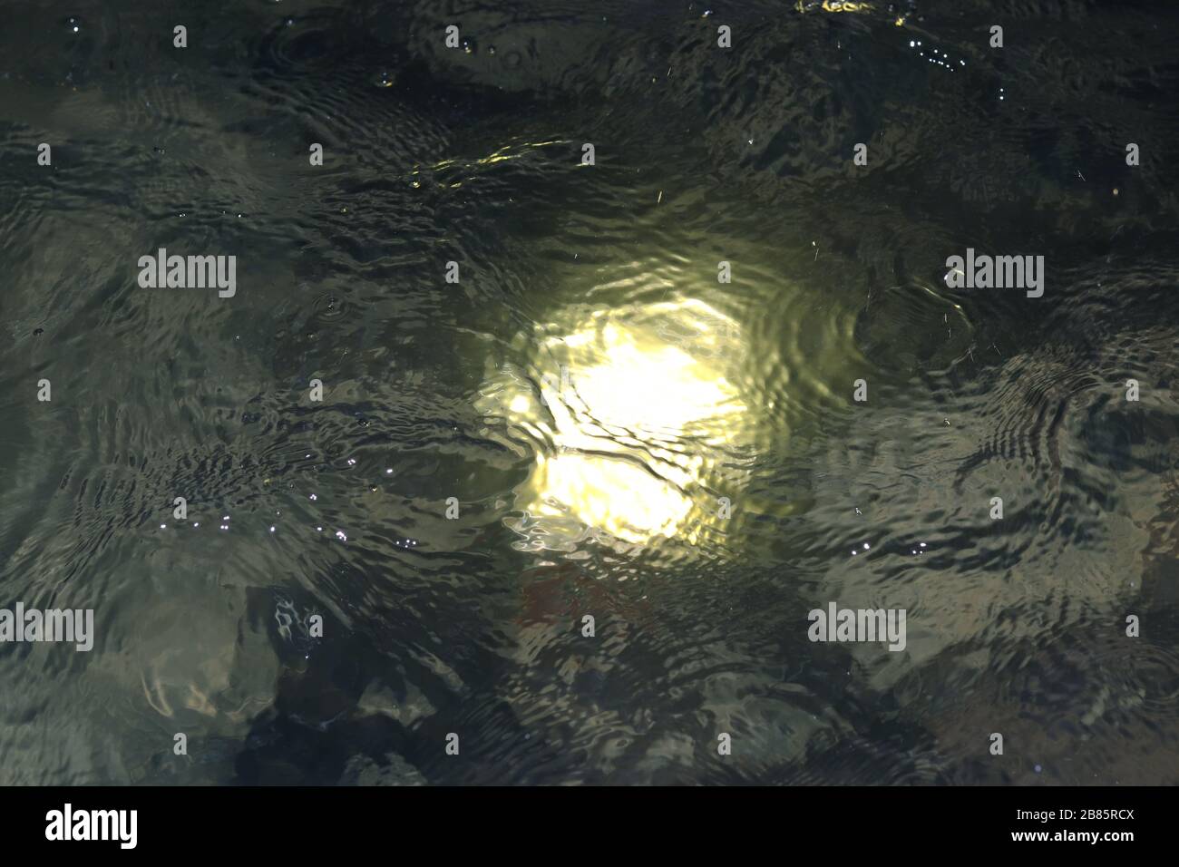 water surface with lighting lamp in swimming pool, underwater lamp ...