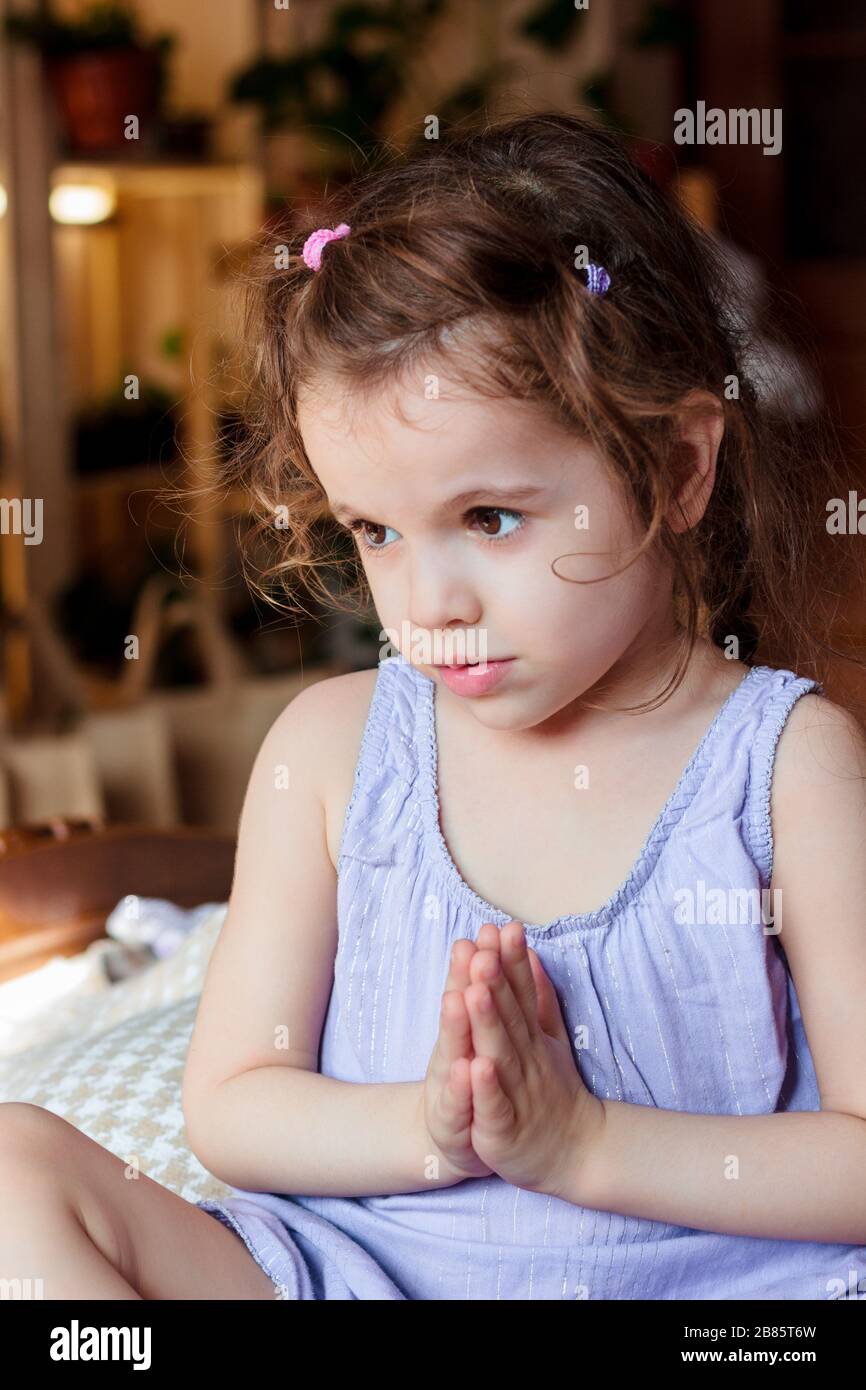 Little kid girl making namaste sing by hands Stock Photo - Alamy