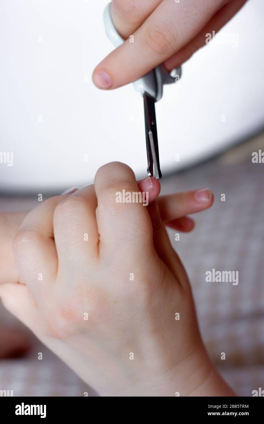 Mother cut nails on finger of baby girl Stock Photo - Alamy