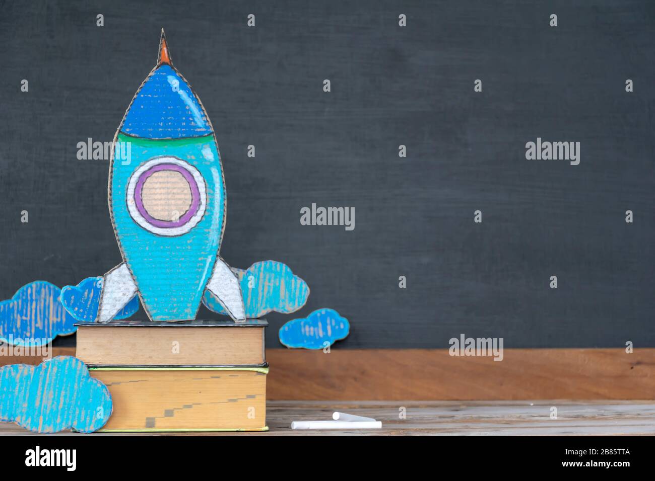 Back to school concept. Paper rockets are located on books. The ...