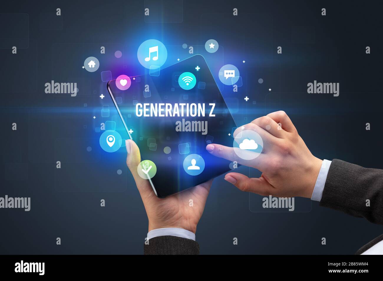 Businessman holding a foldable smartphone with GENERATION Z inscription ...