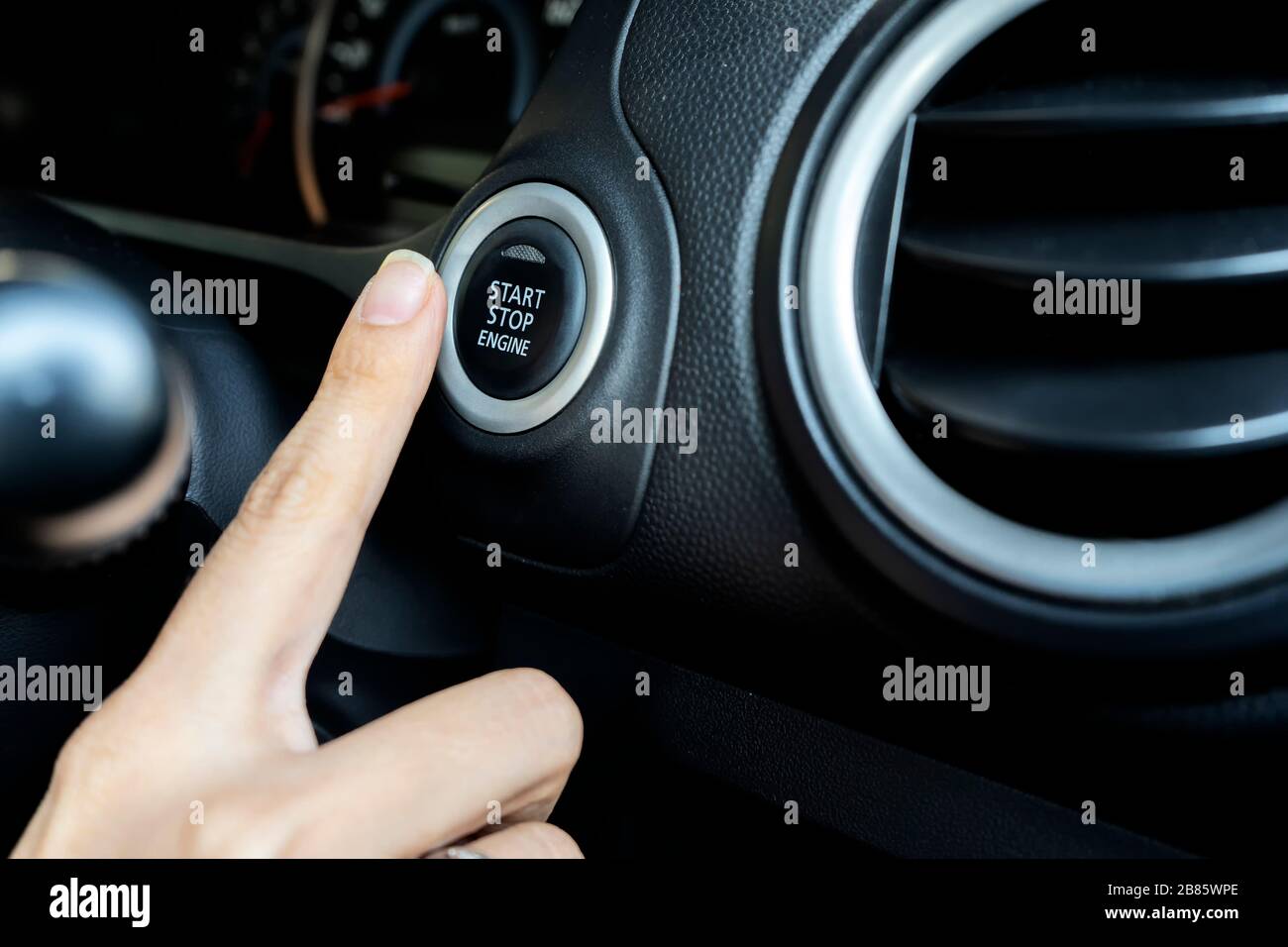 Using the push button to start and stop engine, The woman's finger is ...