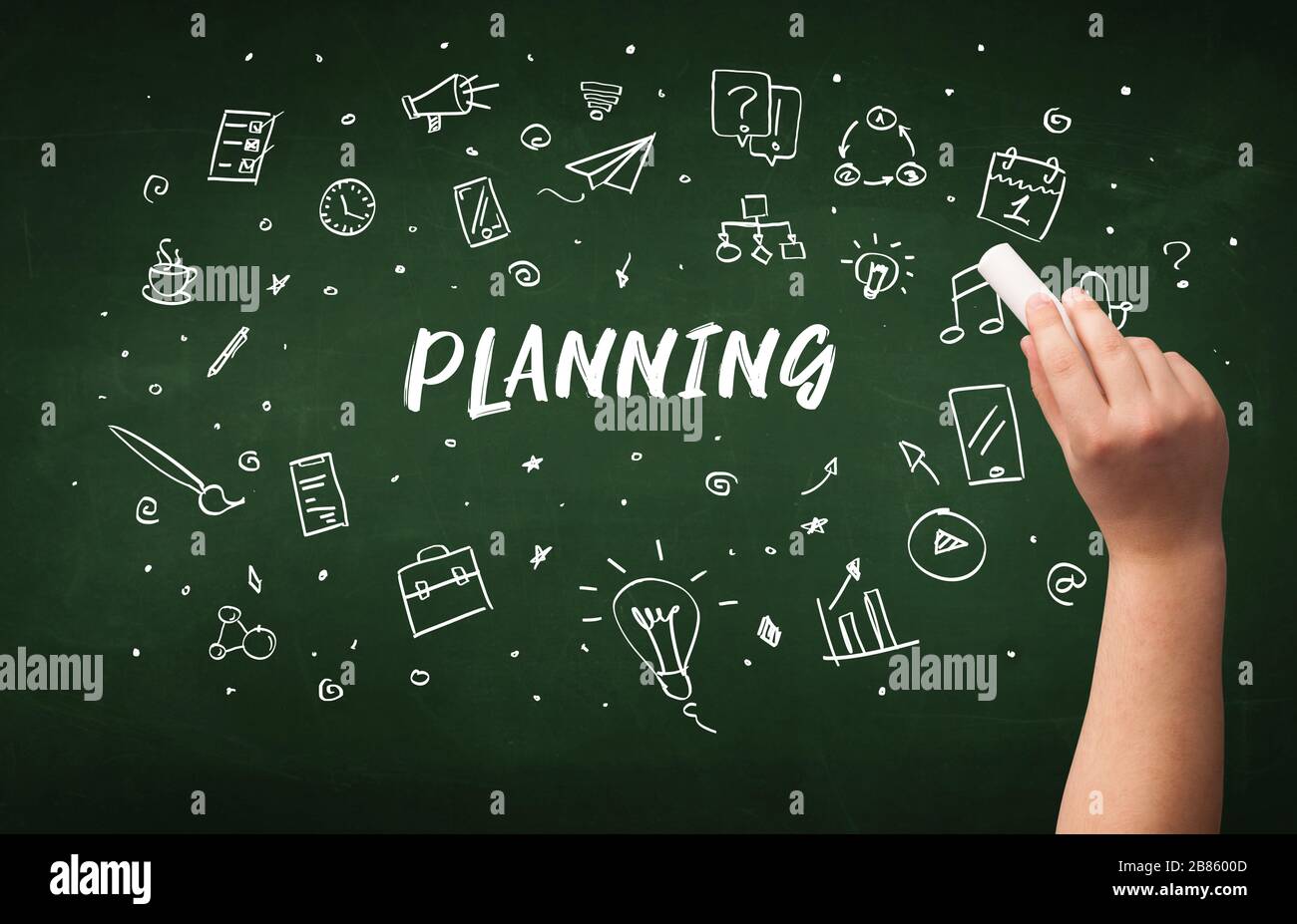 Hand drawing PLANNING inscription with white chalk on blackboard ...