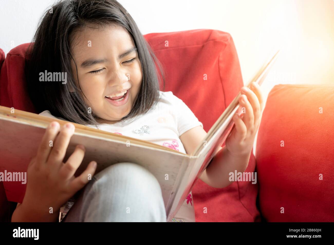 Cute asian girl She is very happy to be reading. Books can add ...
