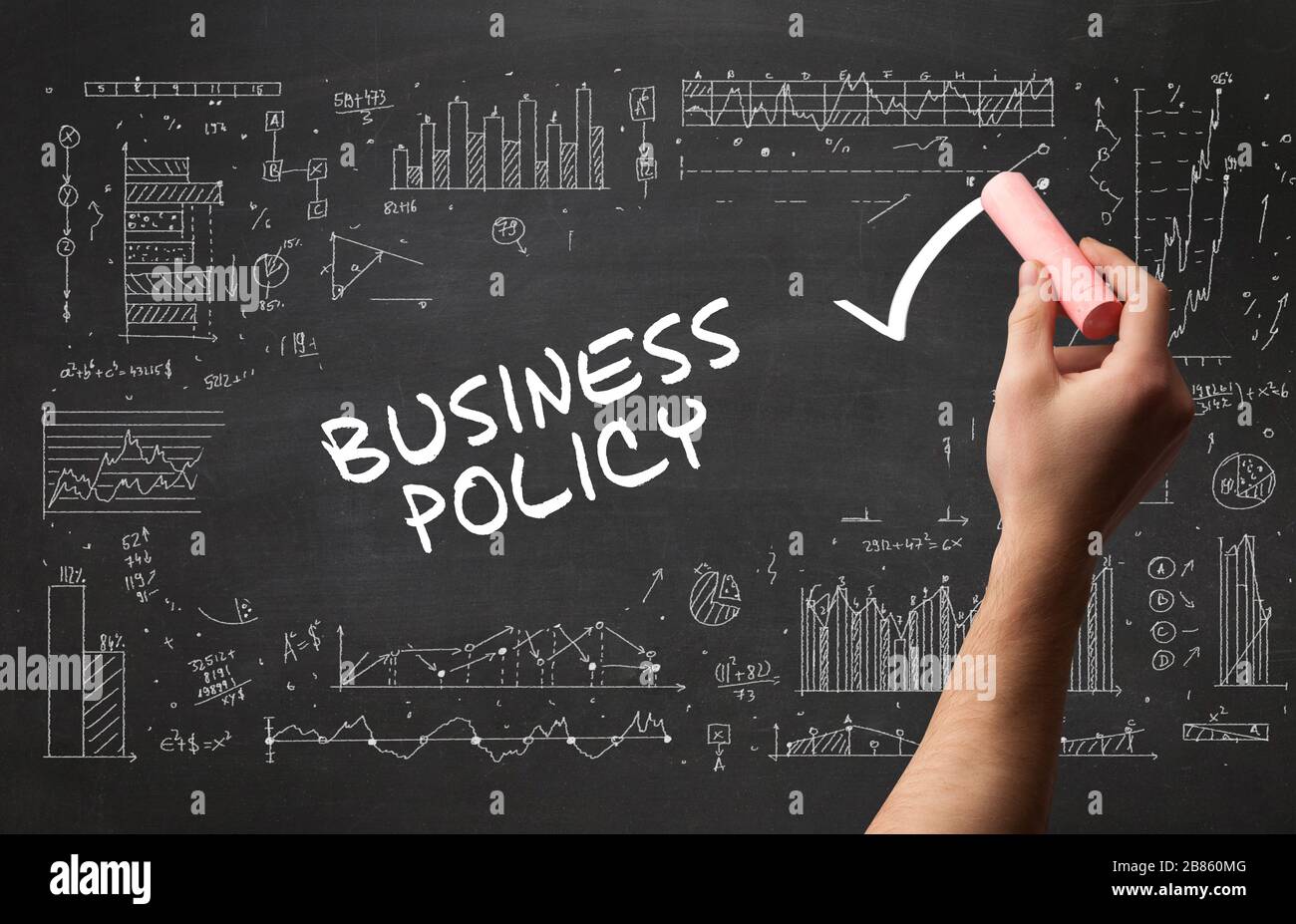 Hand drawing BUSINESS POLICY inscription with white chalk on blackboard ...