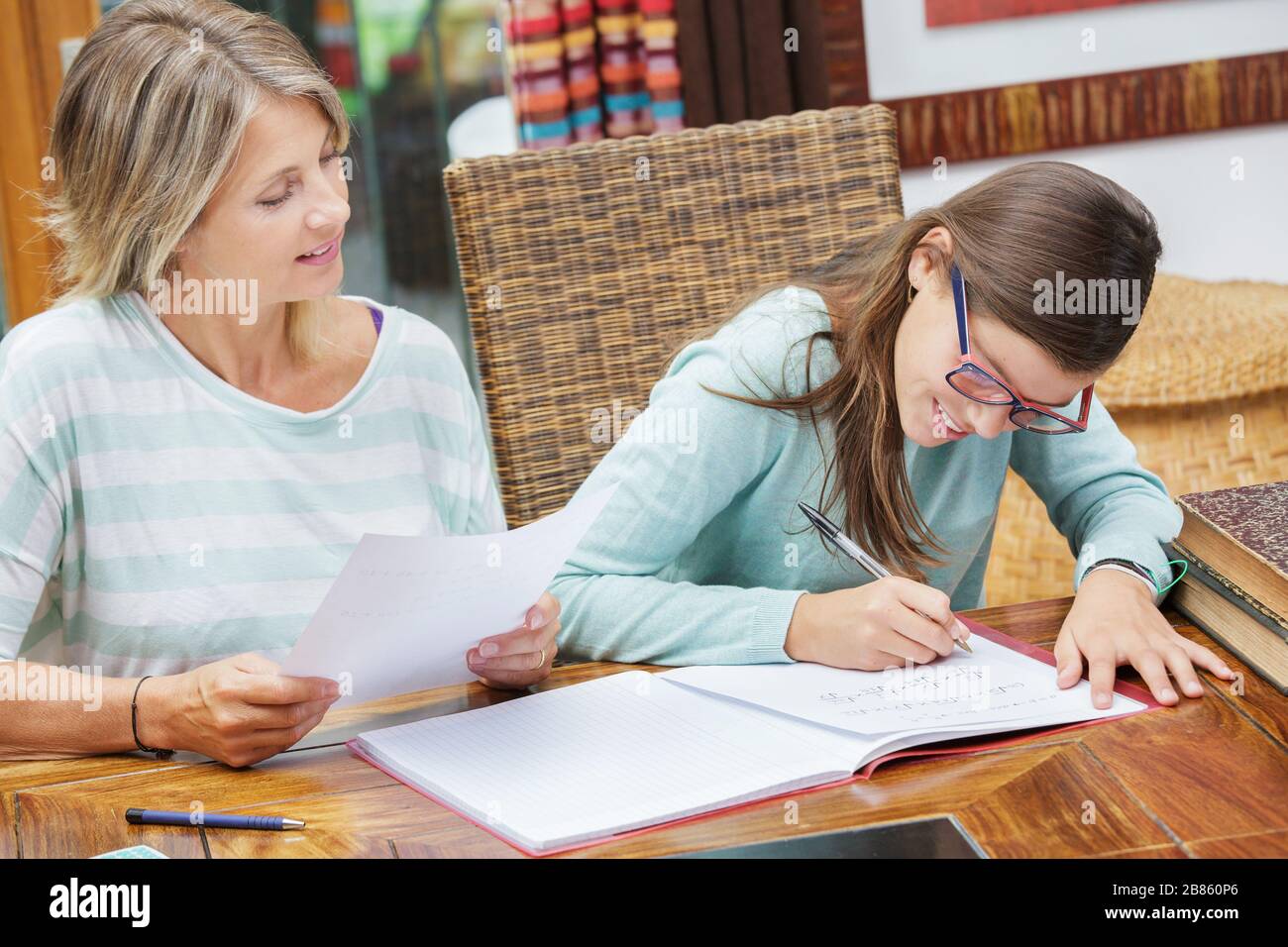 pretty student girl taking tutoring courses with beautiful blond ...