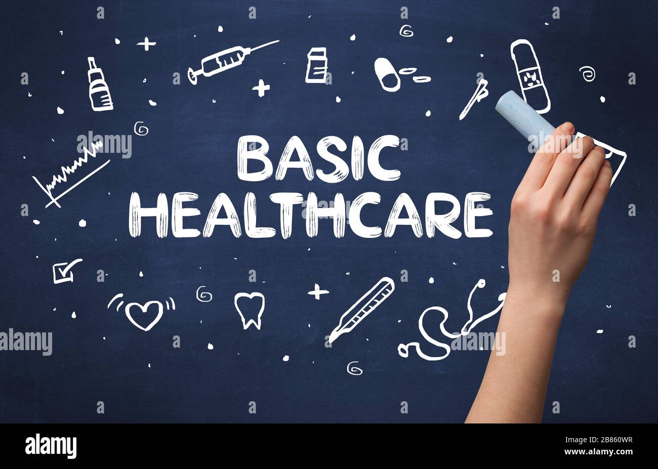 Hand drawing BASIC HEALTHCARE inscription with white chalk on ...