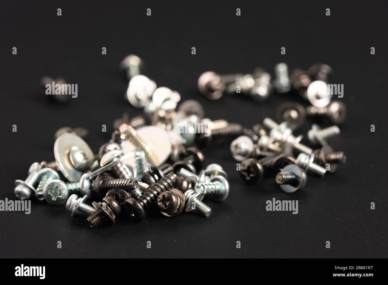 Screws and bolts fasteners industrial black background Stock Photo - Alamy