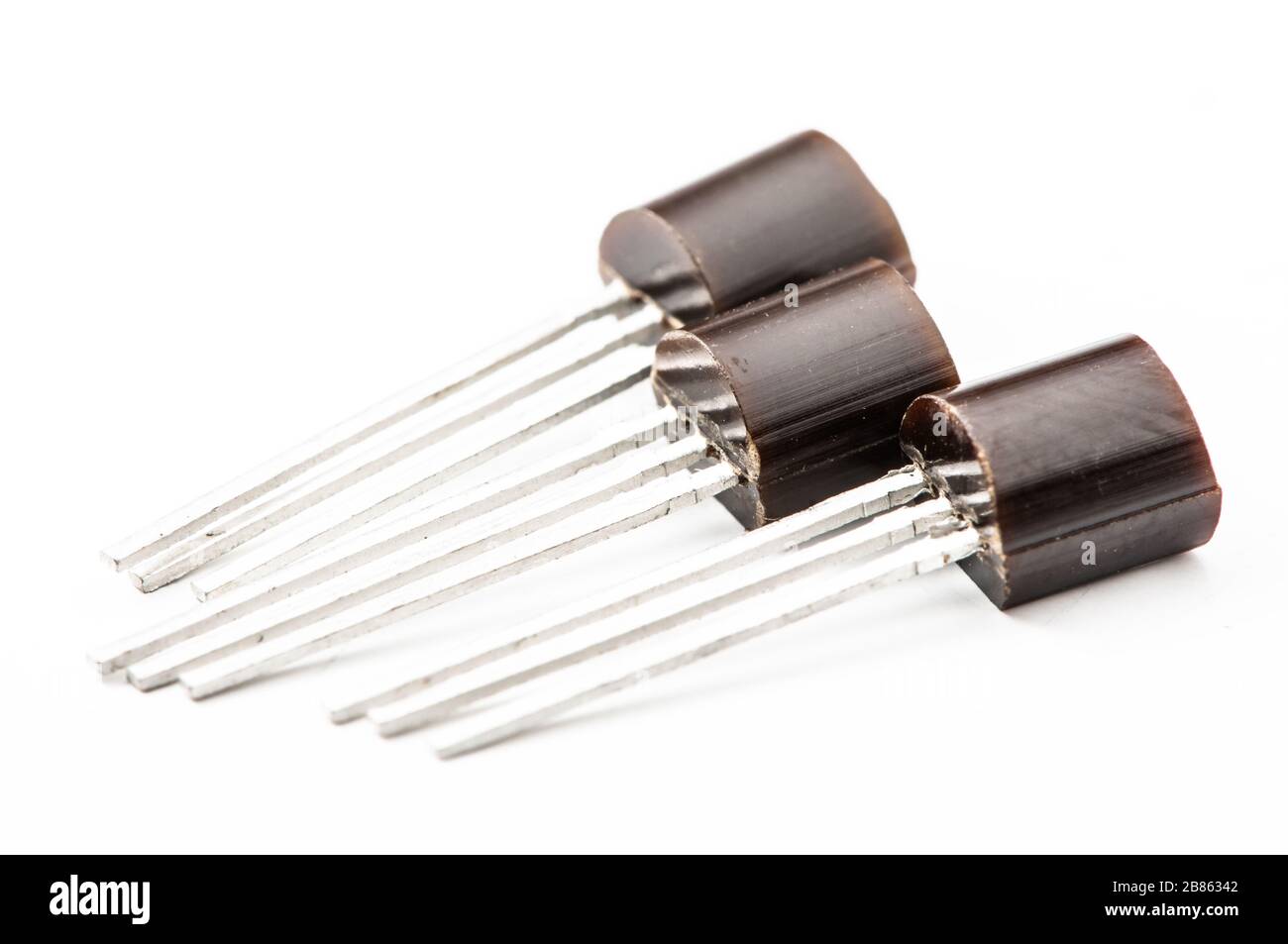 Various electronic components, TO-92 case transistors close-up on white ...