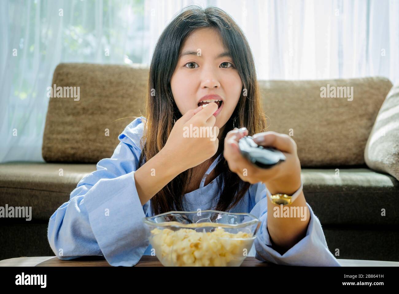Person using remote control hi-res stock photography and images - Alamy