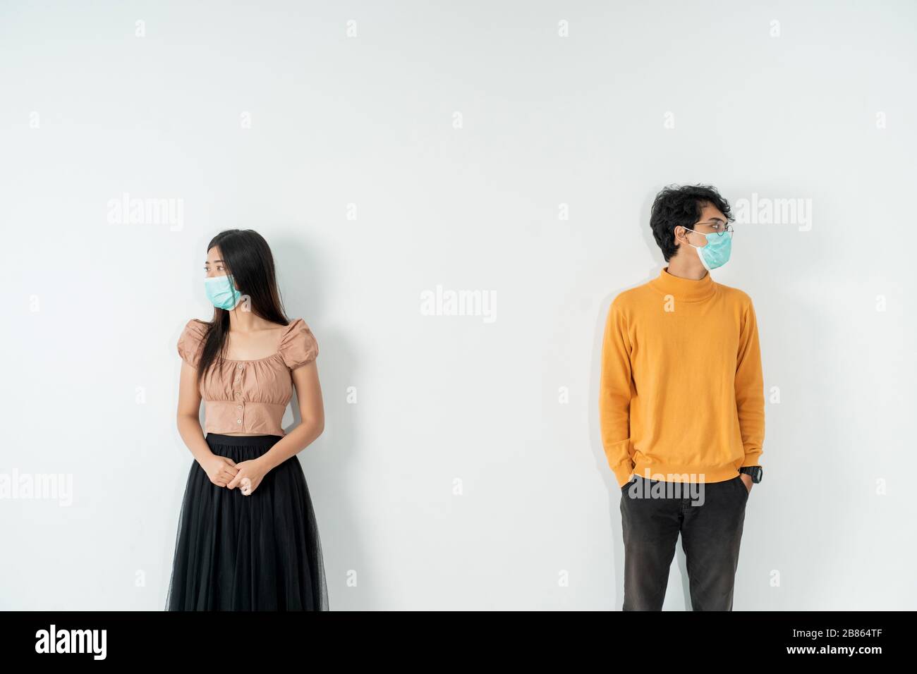 social distancing. people with masks keep their distance during virus ...