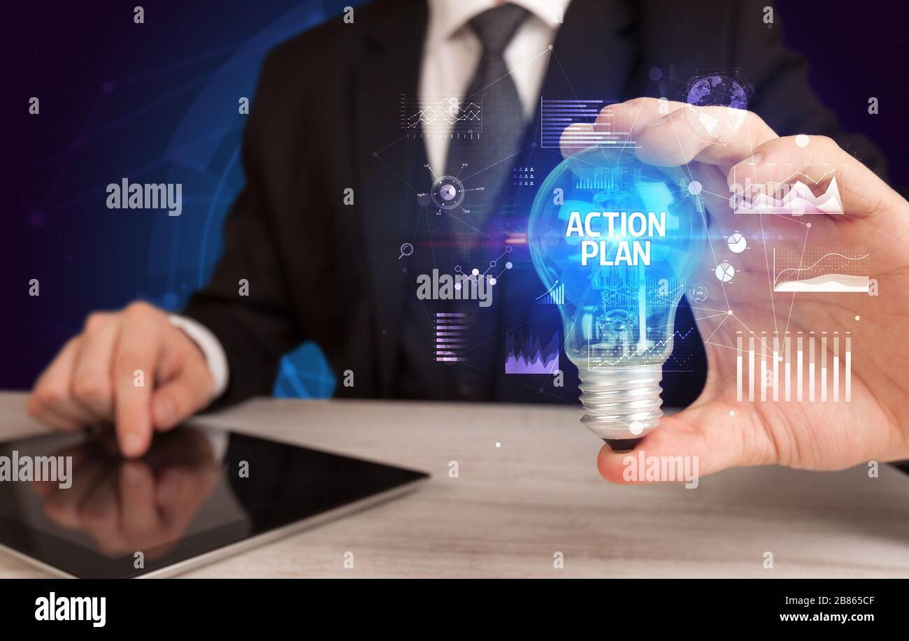 Businessman holding lightbulb with ACTION PLAN inscription, Business ...