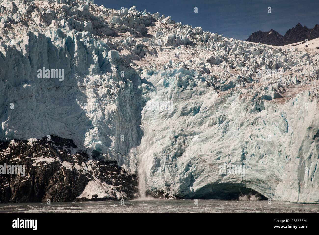 Horizontal shot of a small icefall of the Aialik Glacier in Aialik Bay ...