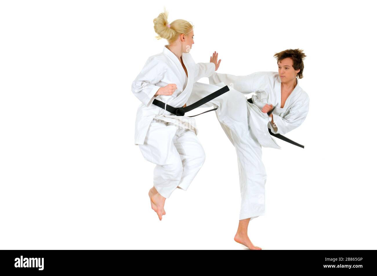 Young karateka couple in a kimono suit with black belts charming girl ...