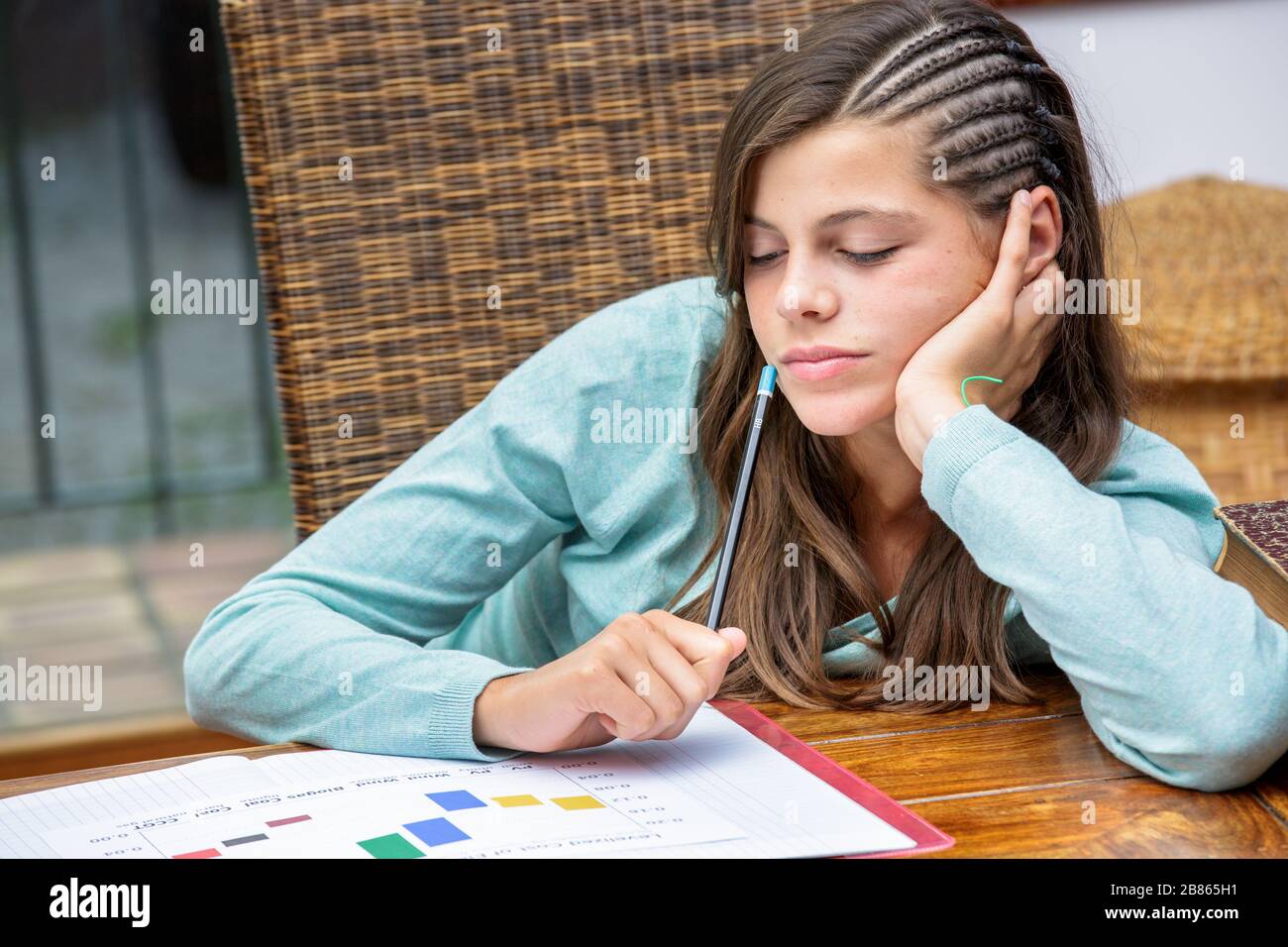 beautiful tired girl student doing her homework with concentration ...