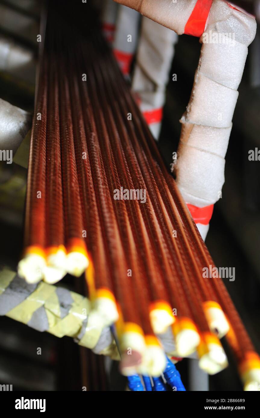 Close-up of a conductors of red copper wire in the kapton insulation ...