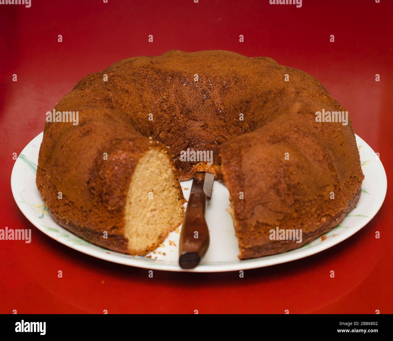 a round freshly baked banana flavored bundt cake Stock Photo - Alamy