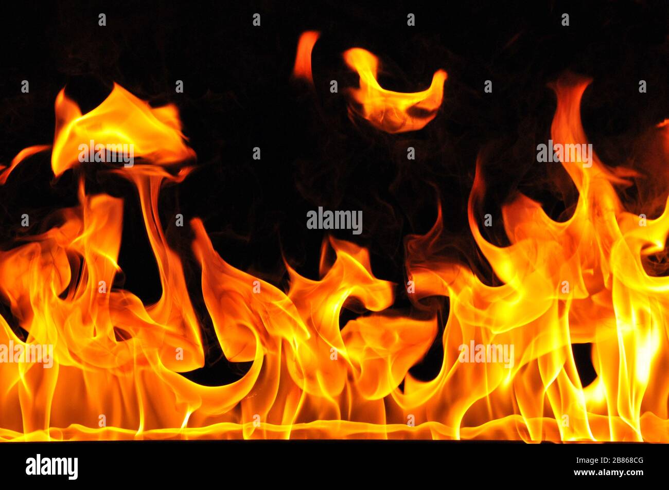 Close-up photo of bright burning fire at the bottom of shot. Flame ...