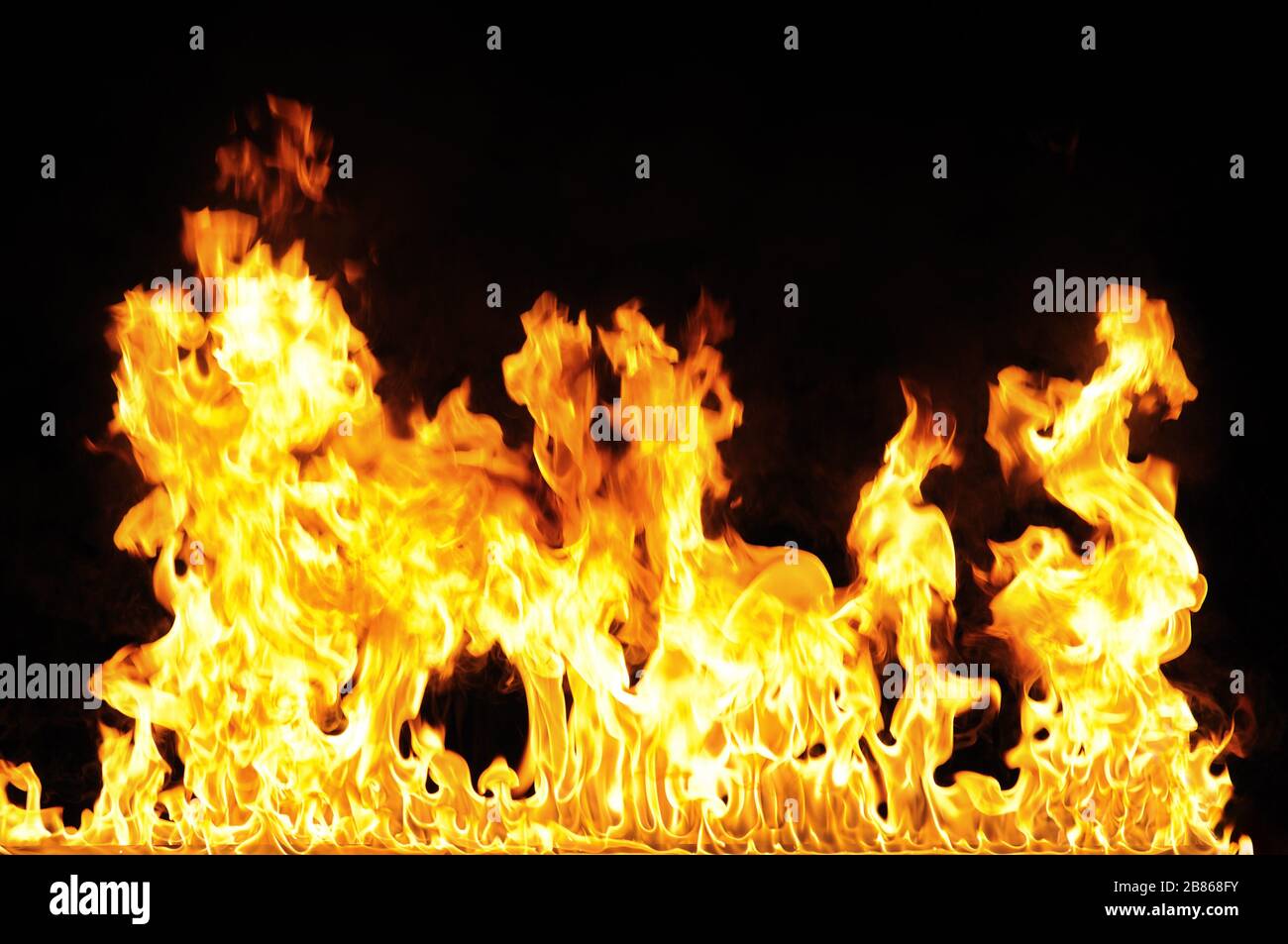 Abstract orange warm fire burns on isolated dark background close-up ...