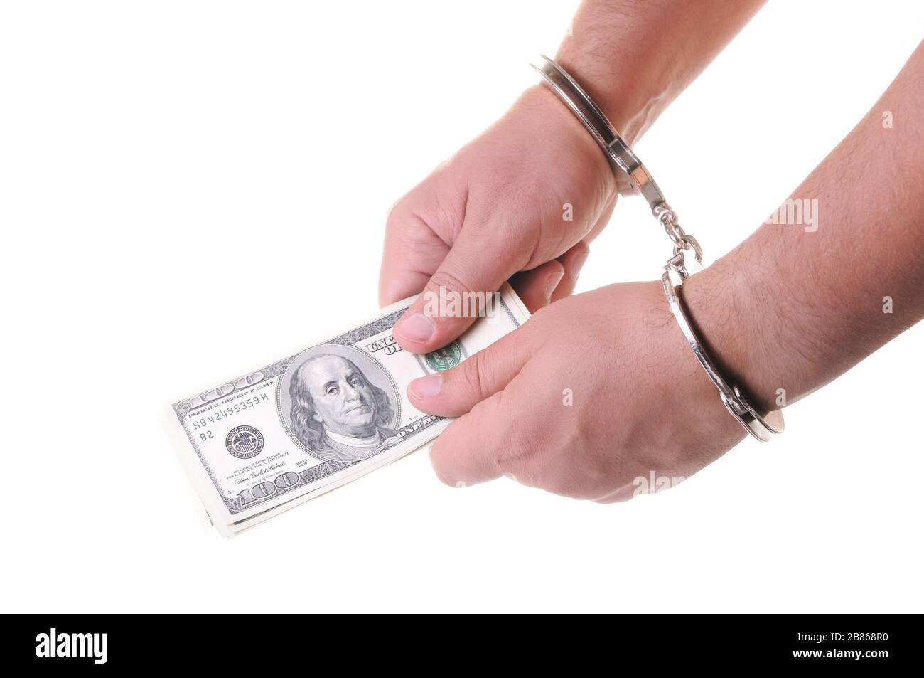 Close-up of mans hand in closed metal handcuff holding stack of ...