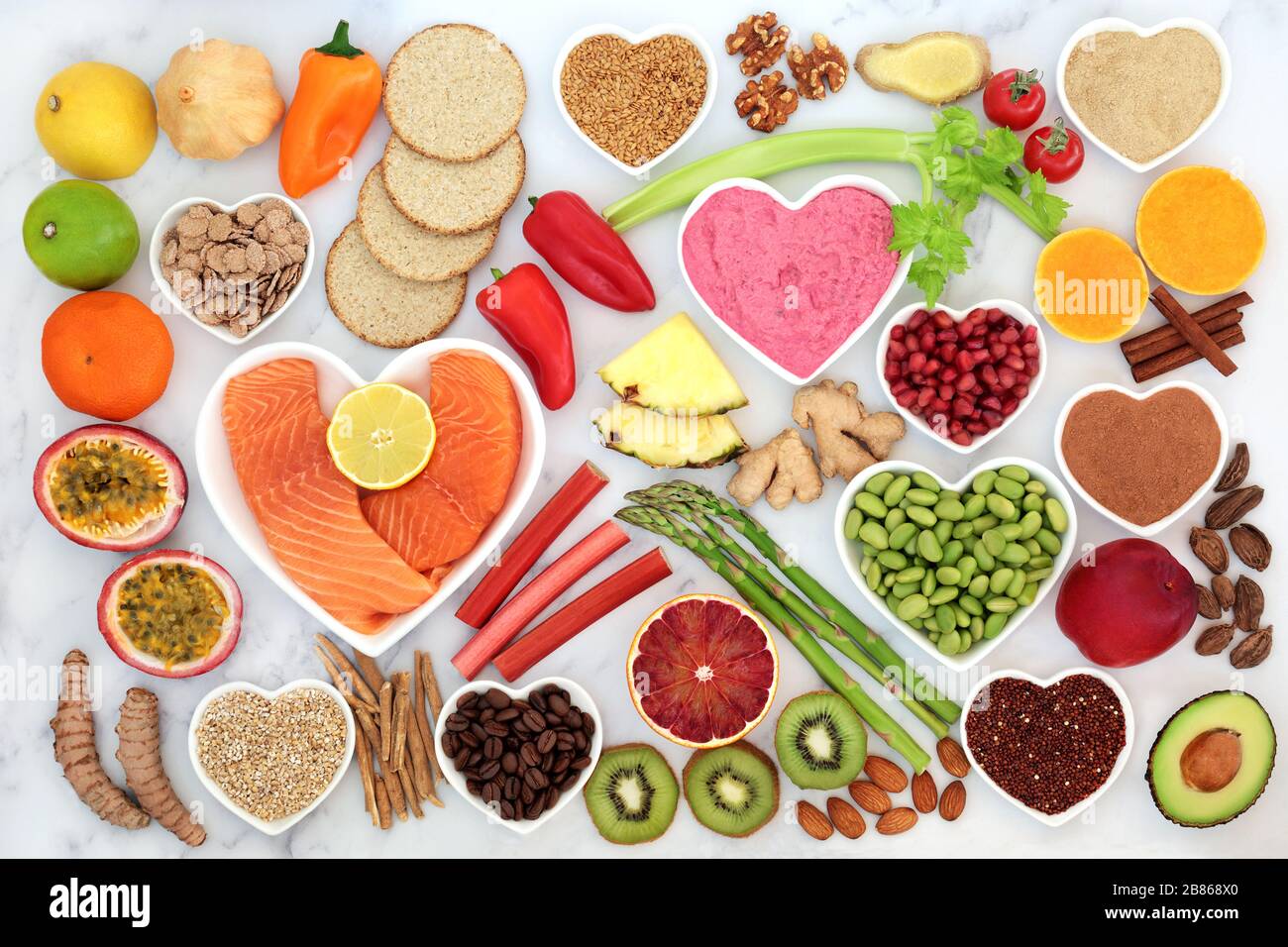 Healthy heart food with fish, fruit, vegetables, nuts, dips, grain ...