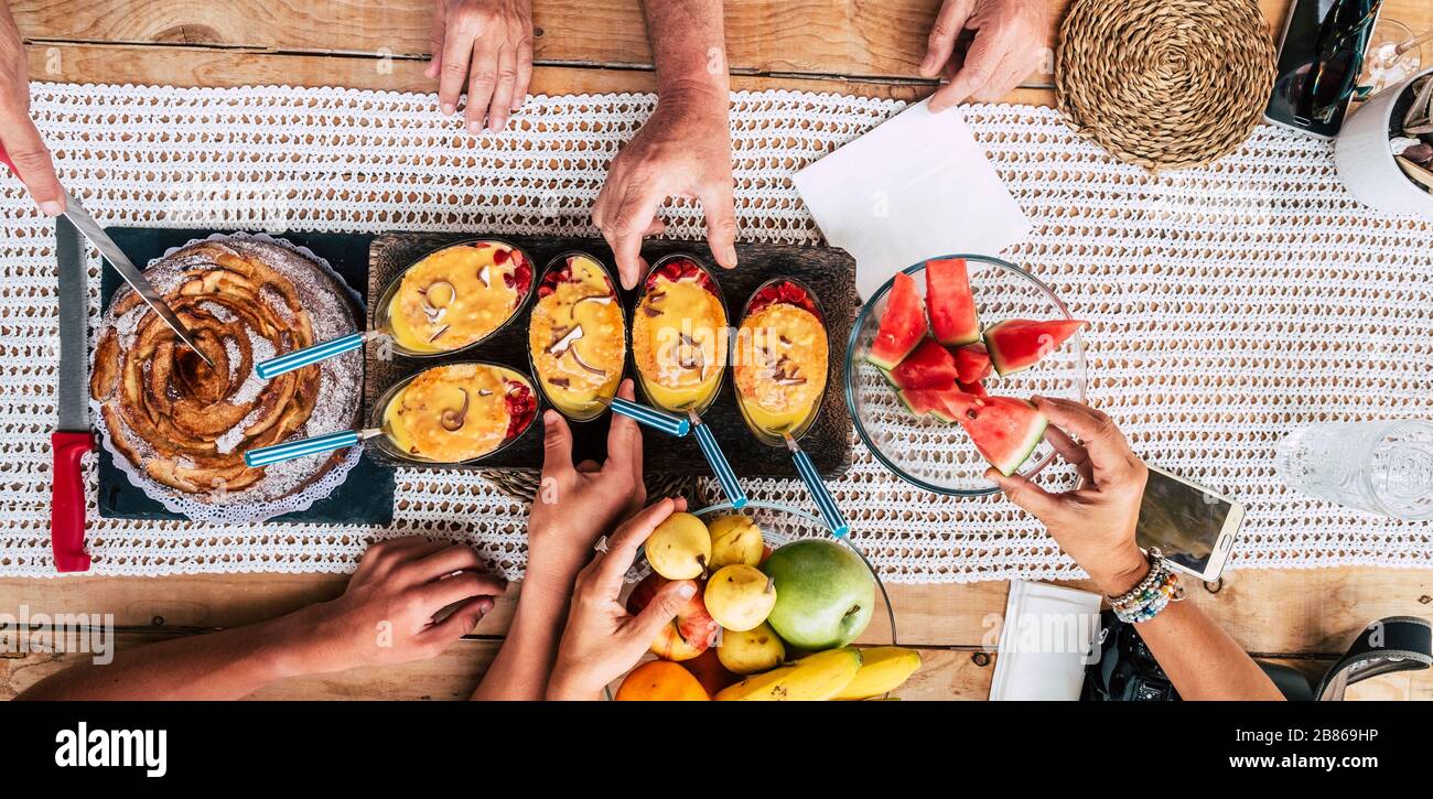 Group of people have lunch together at home enjoying time - above view ...