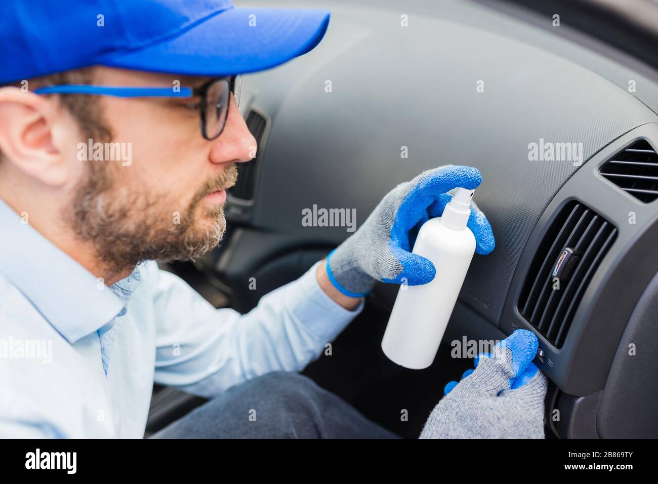 Man cleansing car vent grille air duct with disinfection liquid Stock ...