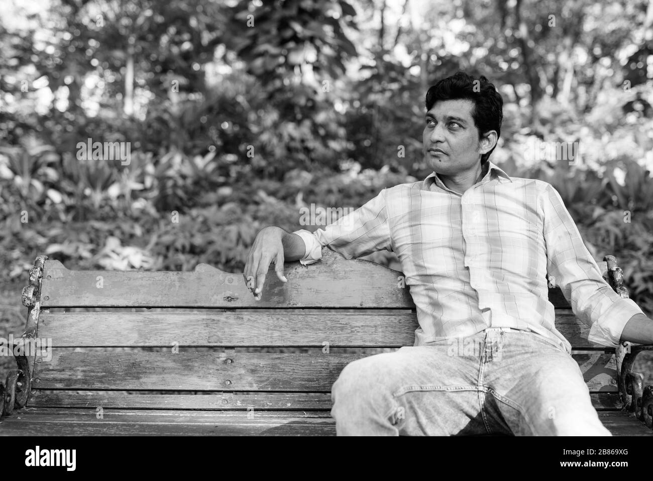 Portrait of Indian man relaxing at the park Stock Photo - Alamy