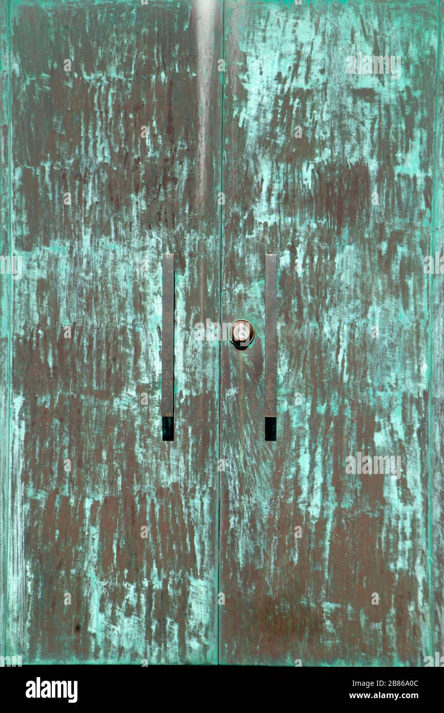 Iron green door in the wall as background and texture.Iron door in the ...