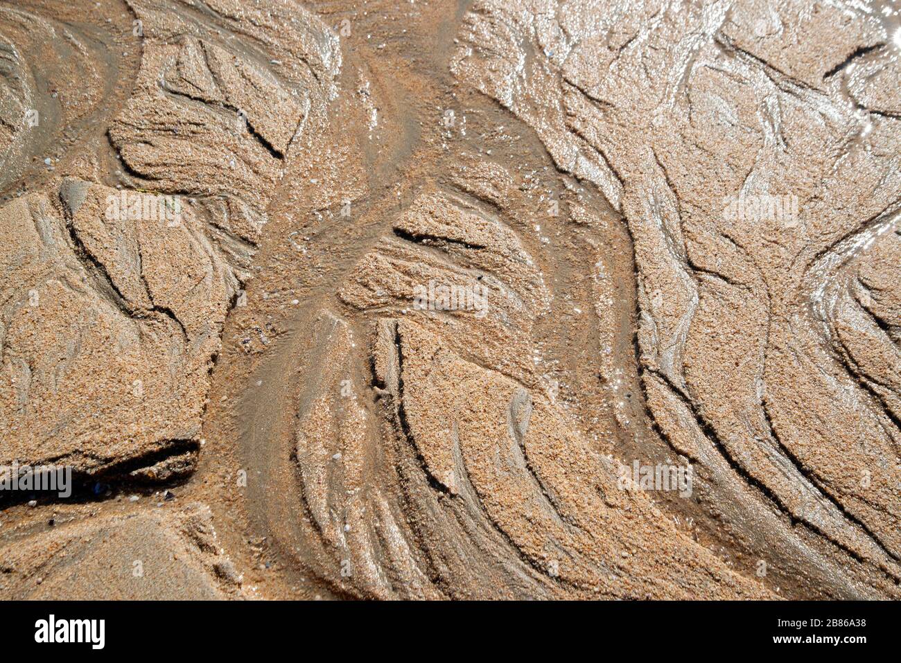 Natural sand patterns on beach at low tide Stock Photo - Alamy