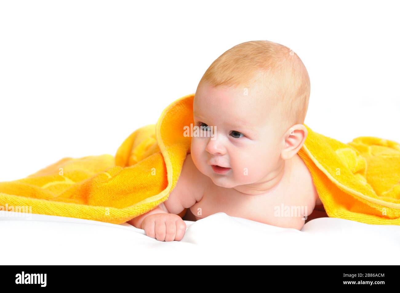 Photo portrait of newborn lying under yellow blanket and looking to ...