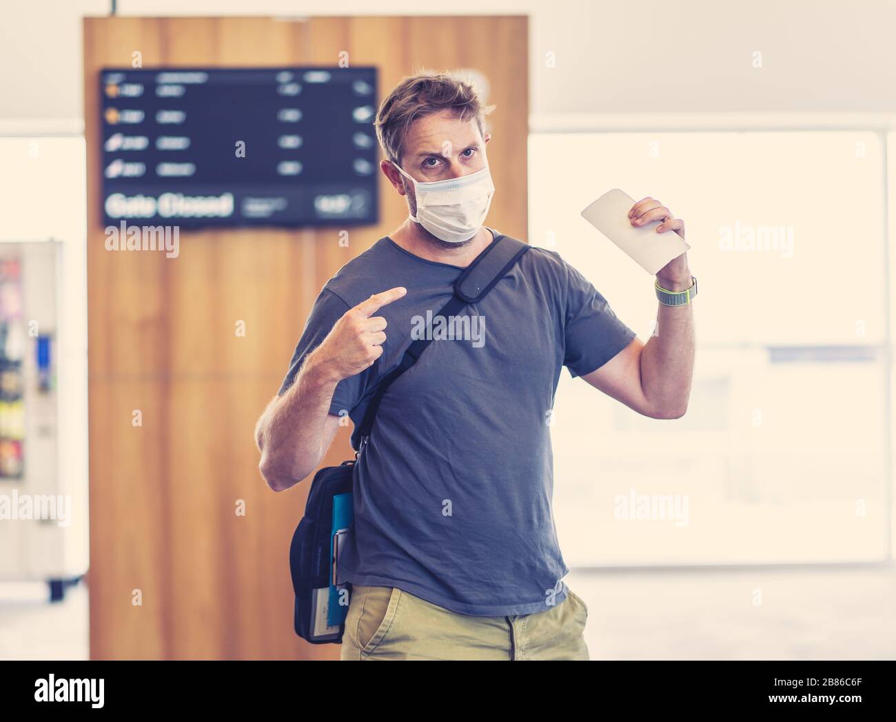 Coronavirus outbreak travel restrictions. Travelers with face mask at ...