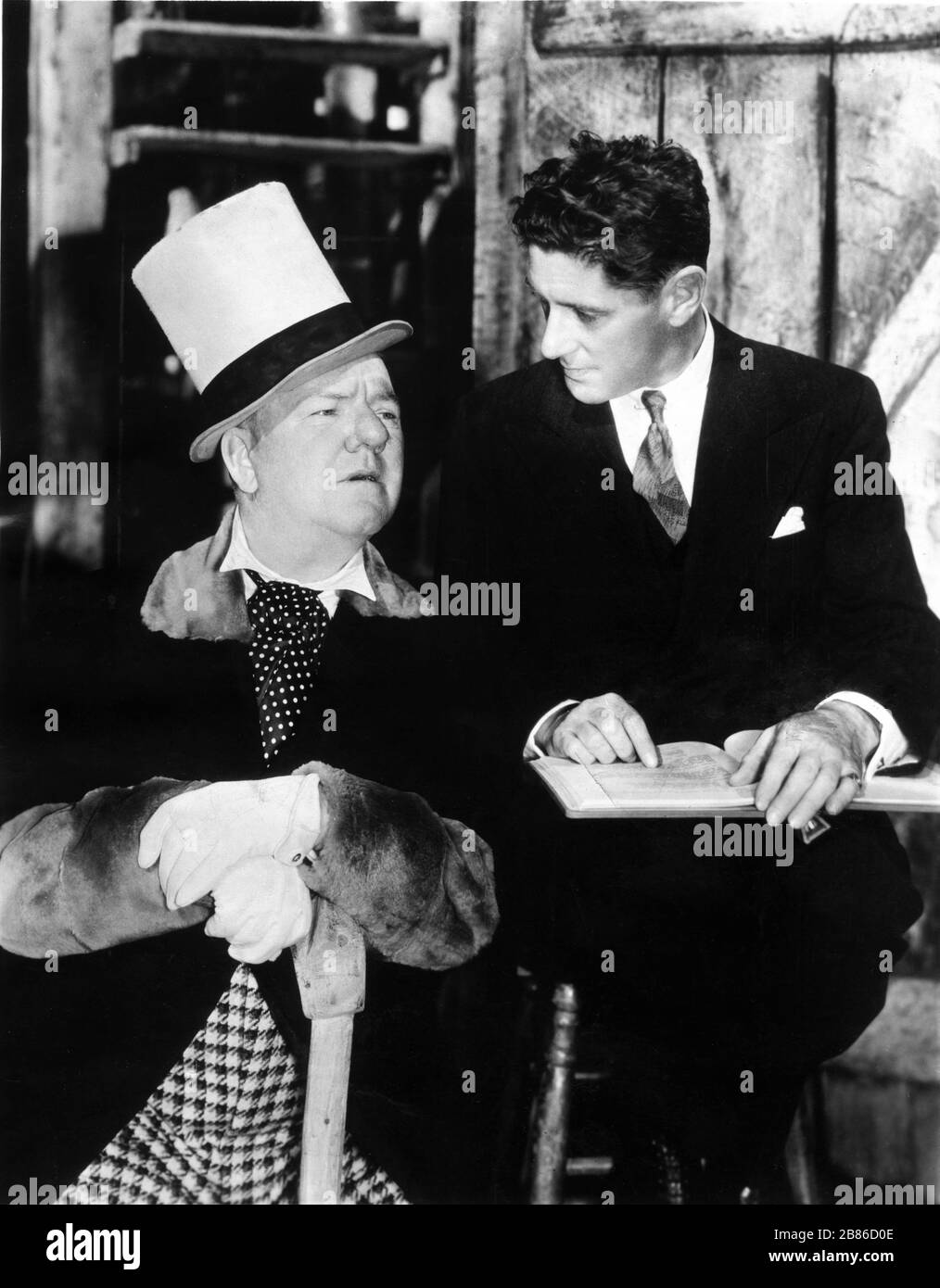 W.C. FIELDS in costume as Professor Eustace McGargle on set candid with Director A. EDWARD ...