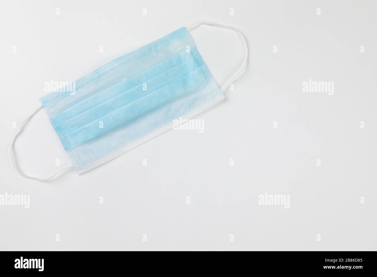 blue surgical medical mask on white background Stock Photo - Alamy