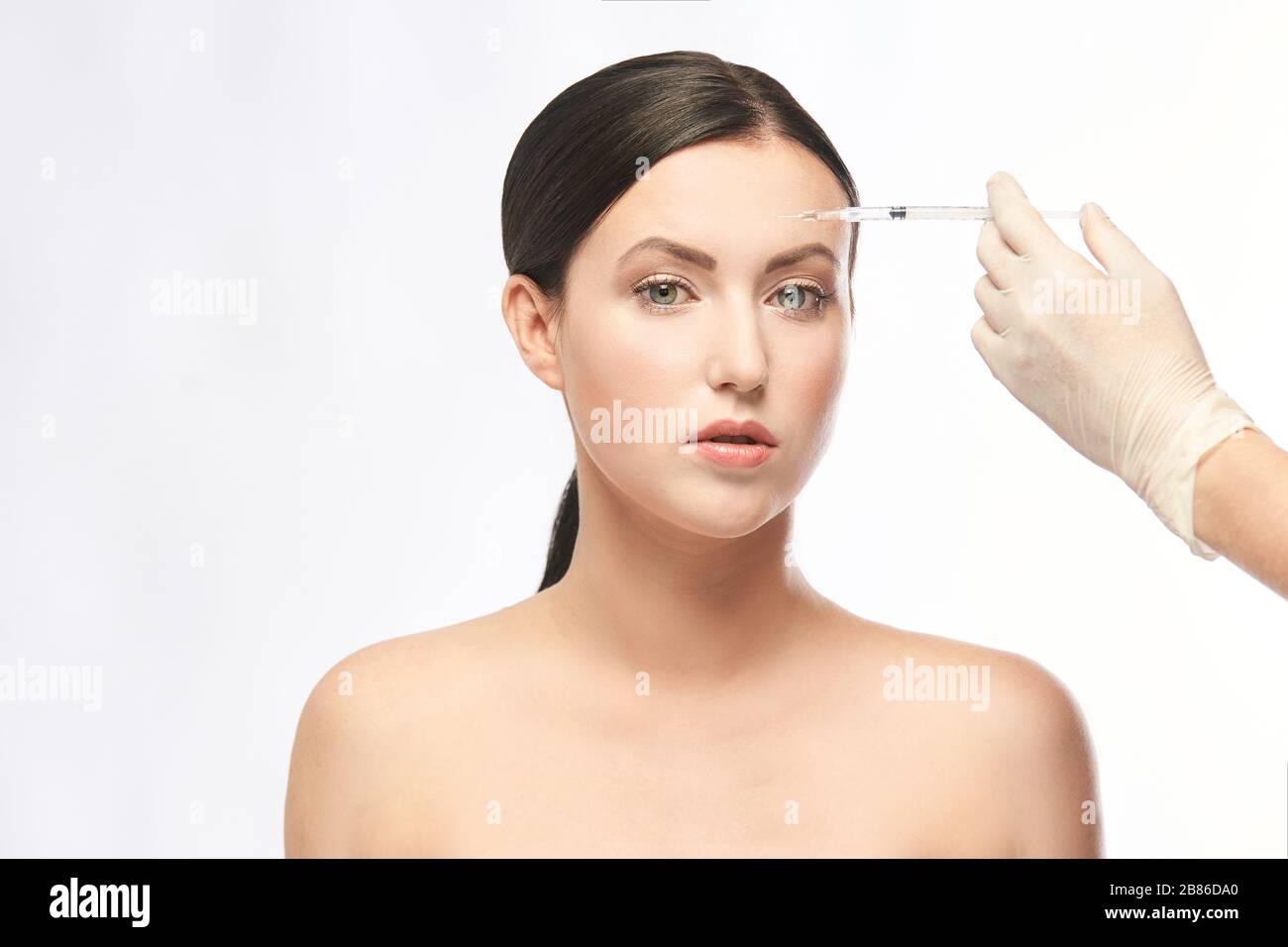 Face needle injection. Young woman cosmetology procedure. Doctor gloves ...