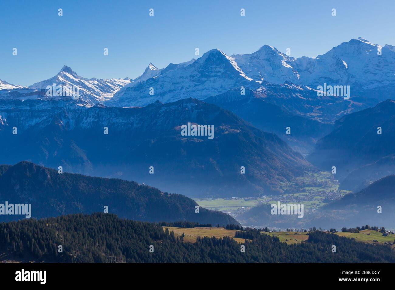 snowcapped Bernese Eiger, Moench and Jungfrau mountains with blue sky ...