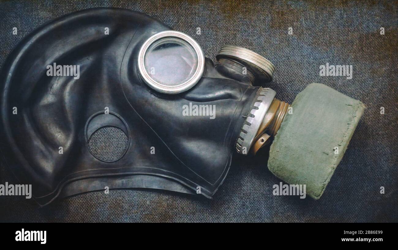 Close up of Protective gas mask with a filter on a gray dirty ...
