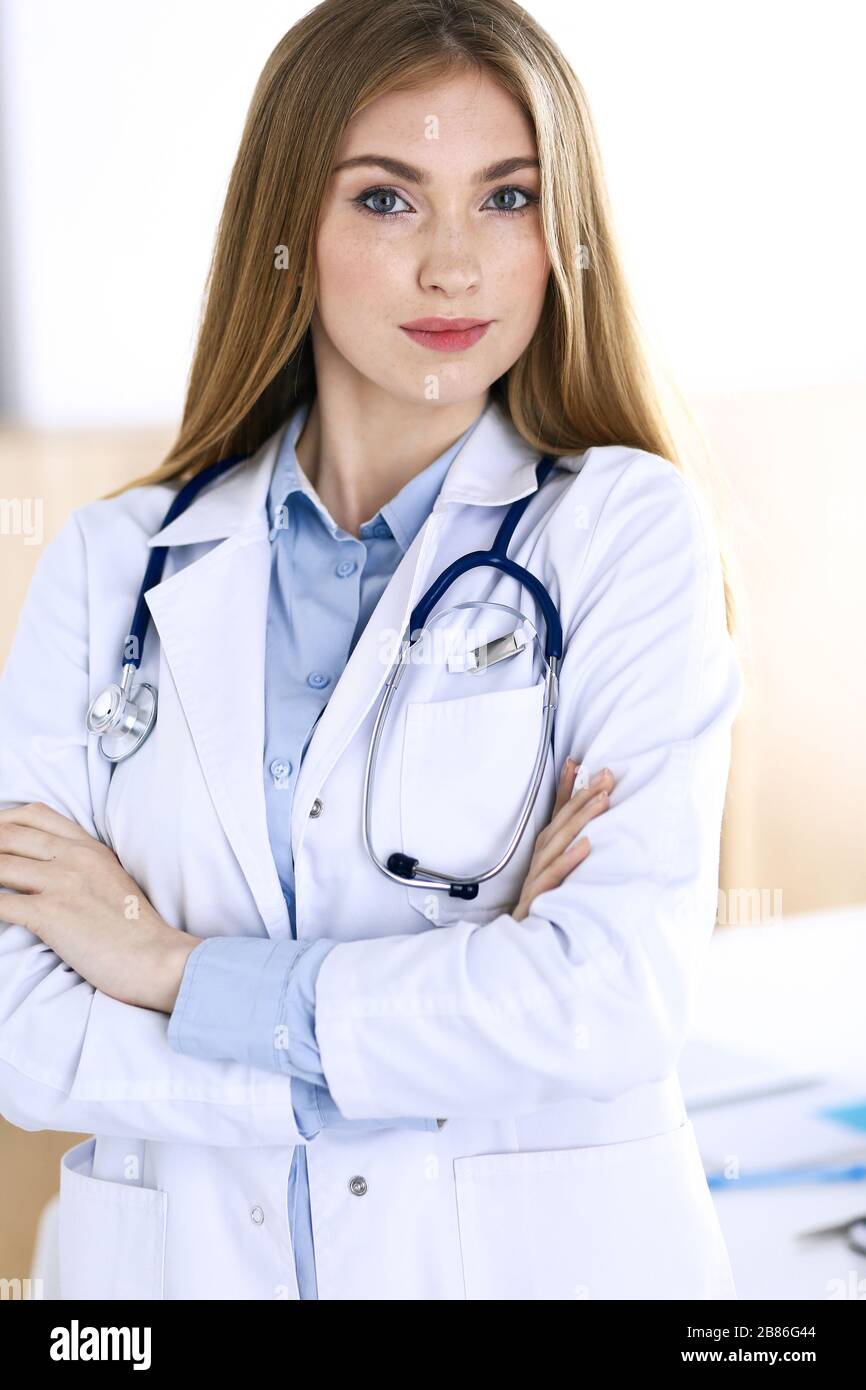 Woman doctor standing in hospital office. Physician at work, life ...