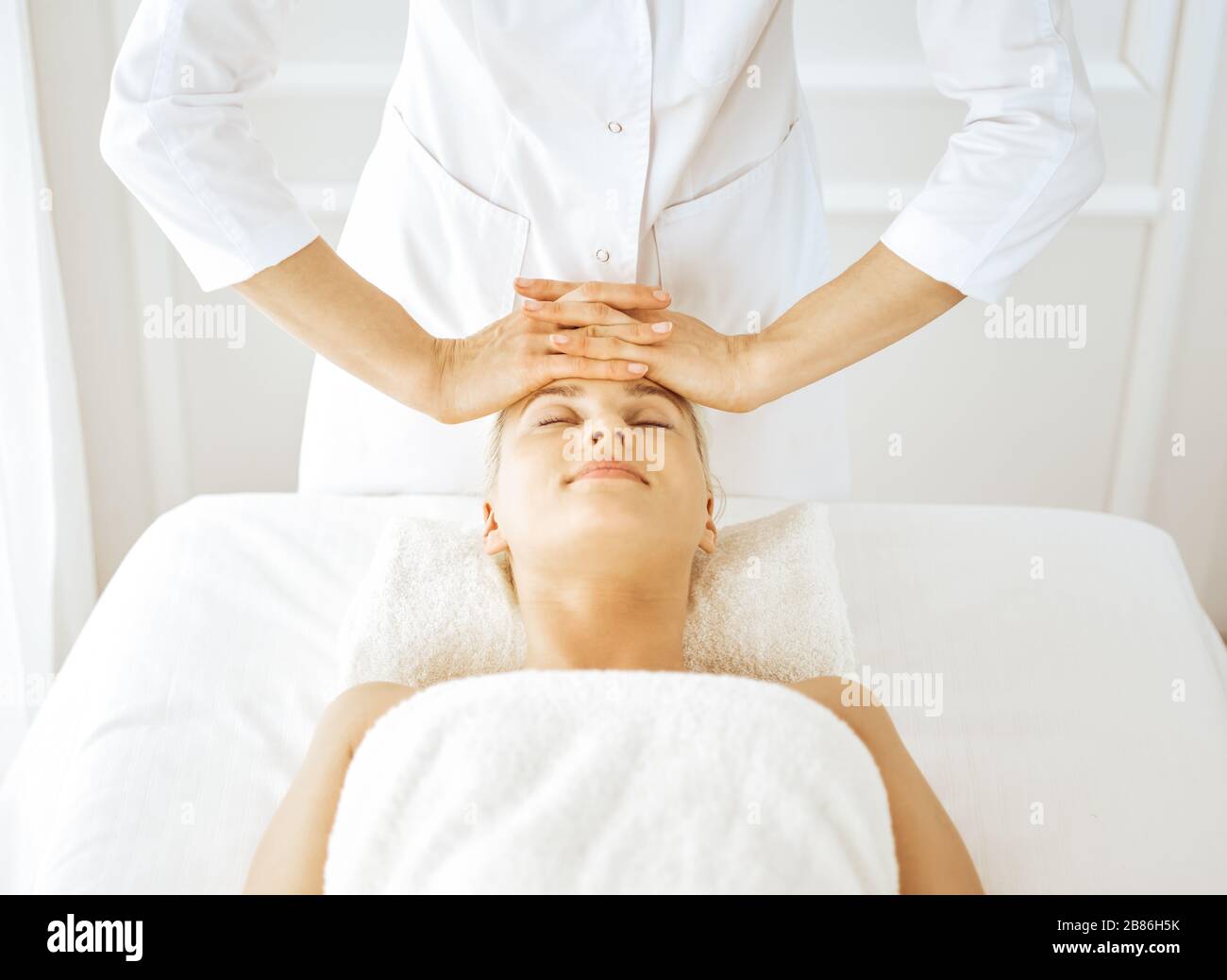 Beautiful Blonde Woman Enjoying Facial Massage With Closed Eyes