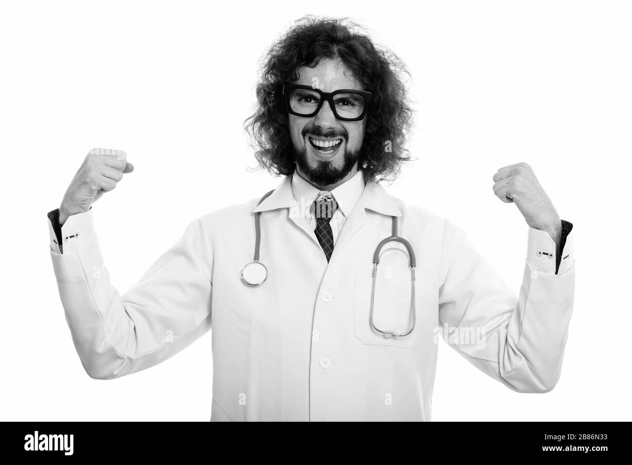 Studio shot of happy man doctor smiling while flexing both arms Stock ...