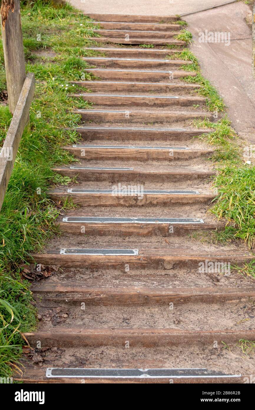 a close up view of wood, concrete and metal stairs leading up a small ...
