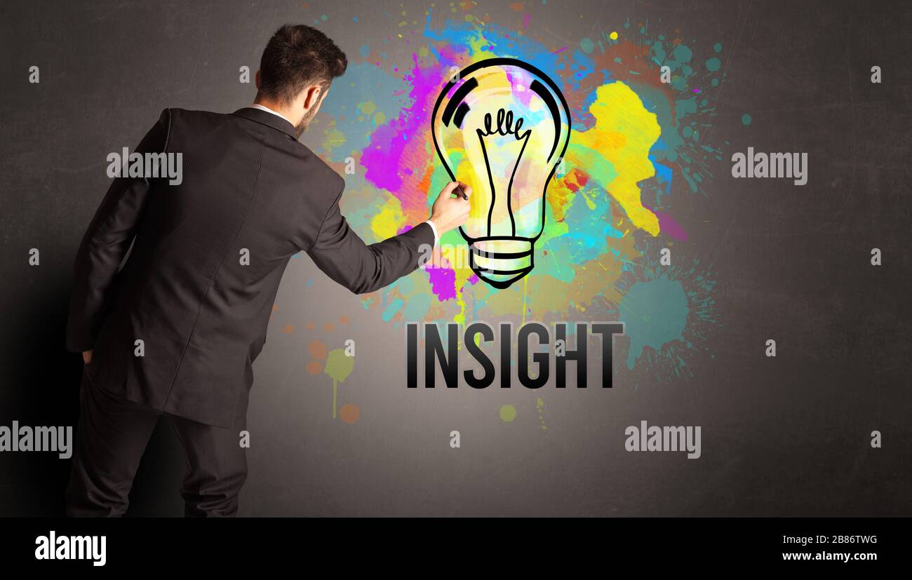 businessman drawing colorful light bulb with INSIGHT inscription on ...