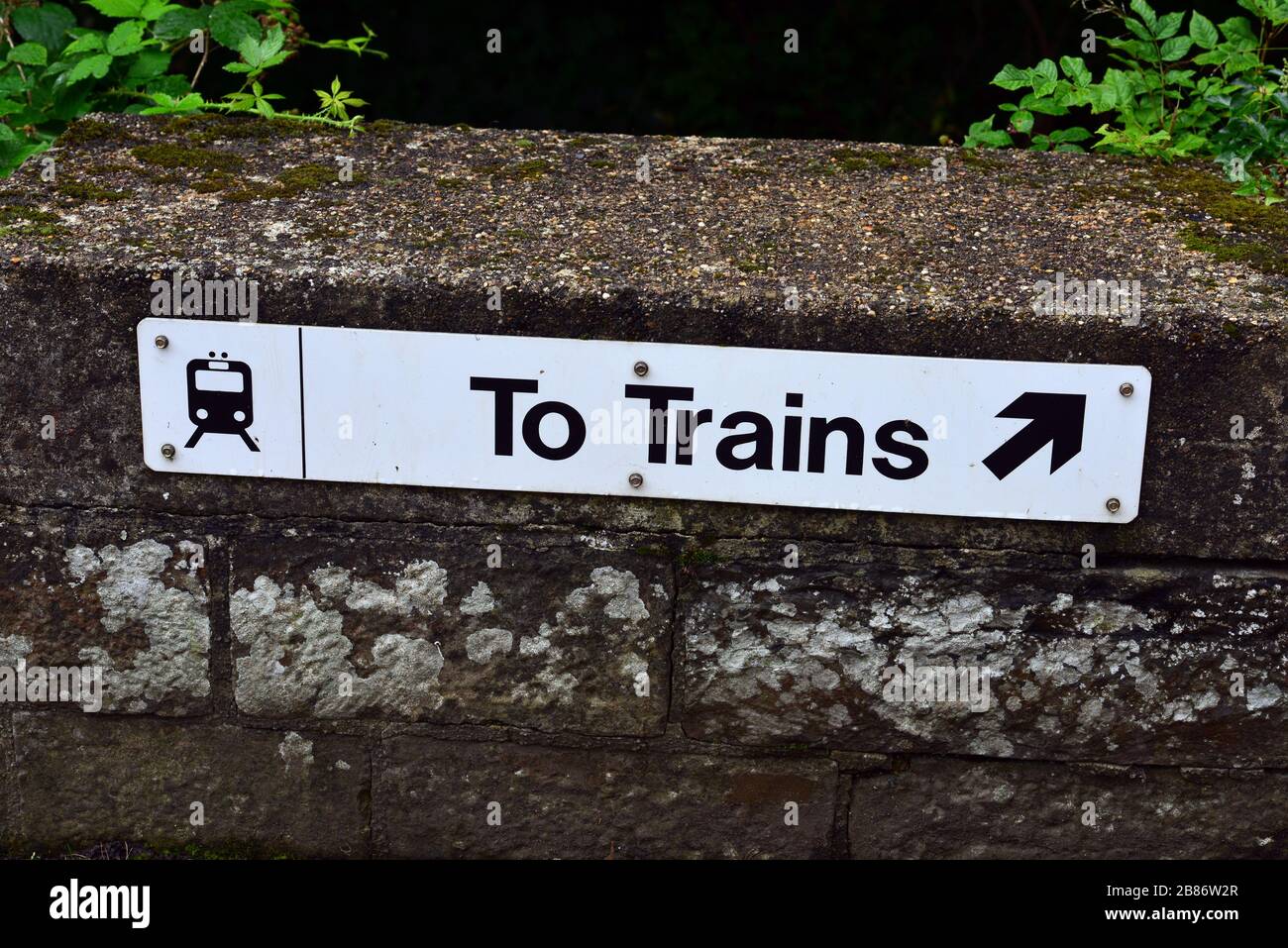 Sign at rural railway station showing direction to platform Stock Photo ...