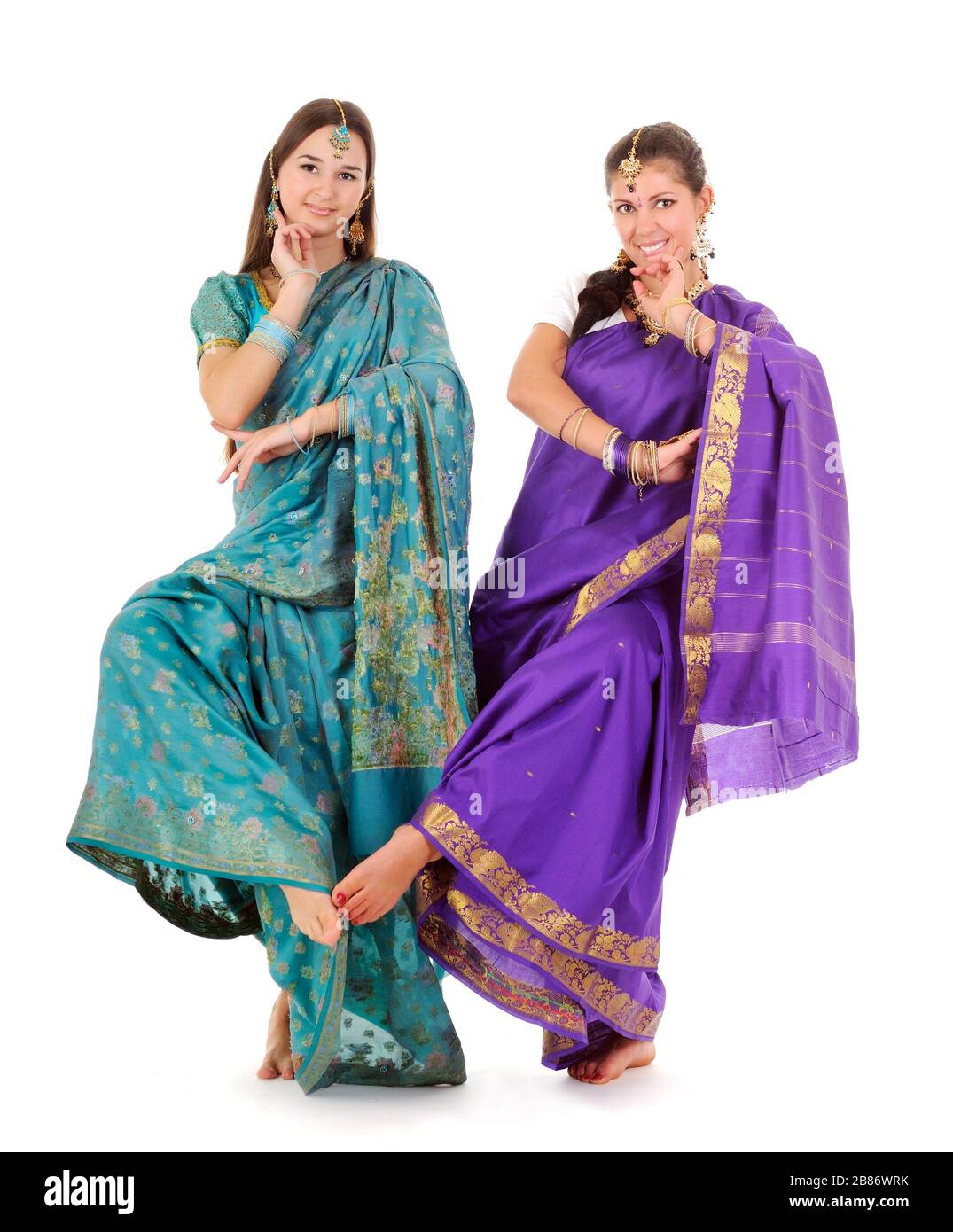 Attractive standing two women in traditional blue and purple indian ...