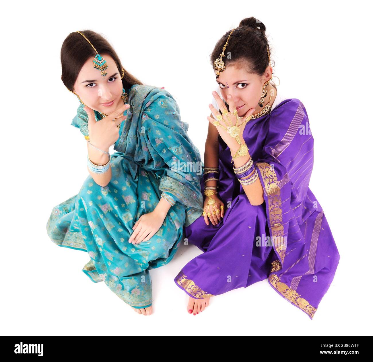 Attractive standing two women in traditional blue and purple indian ...
