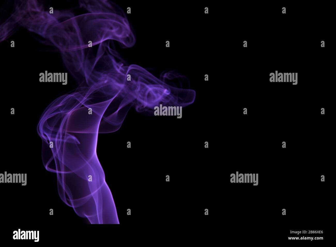 Abstract purple smoke swirling on a black background Stock Photo - Alamy