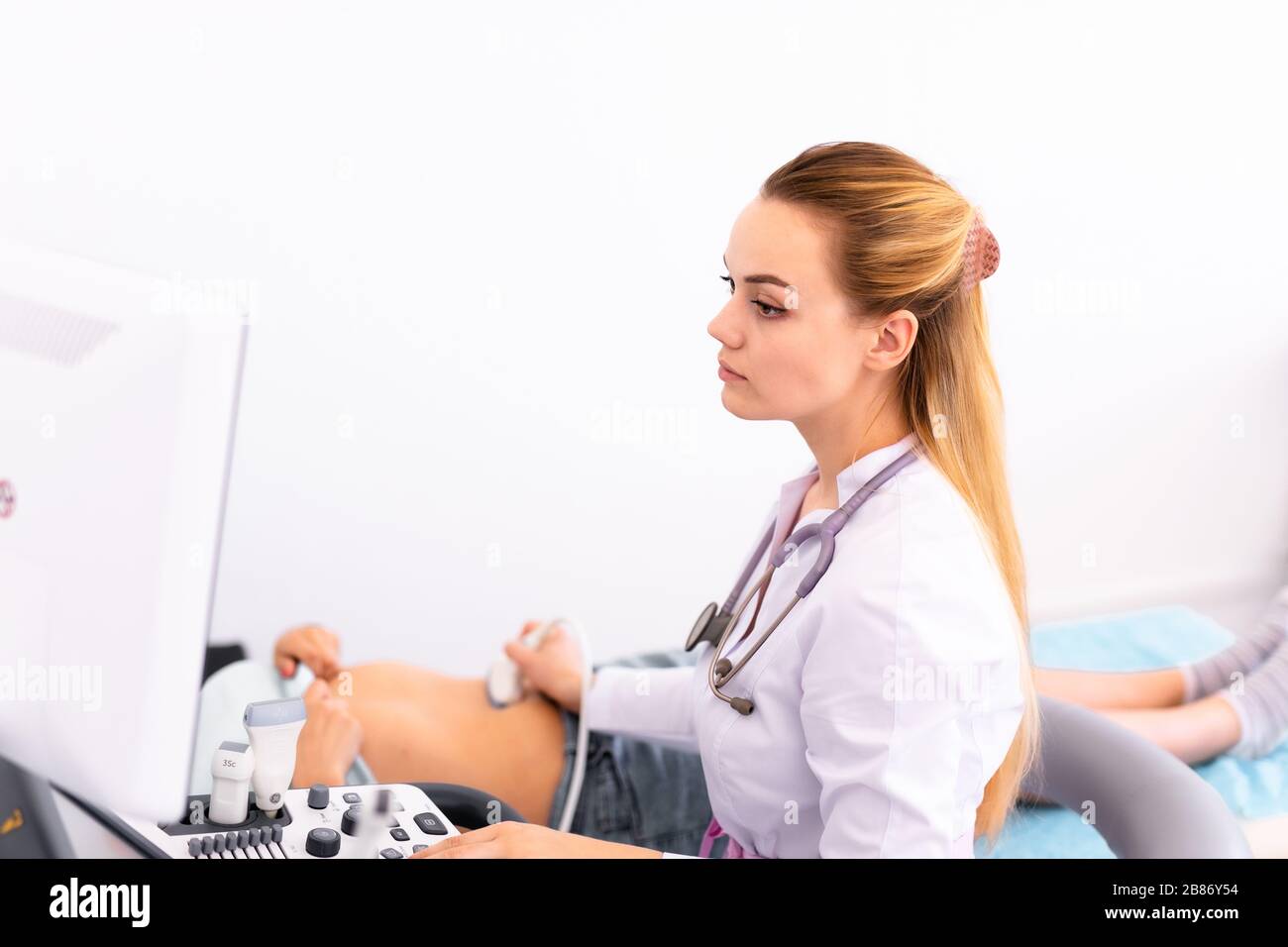 Ultrasound sensor of modern ultrasonic scanner in young woman doctor's ...