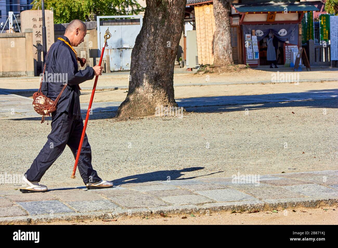 Monk walking on the sidewalk Stock Photo - Alamy