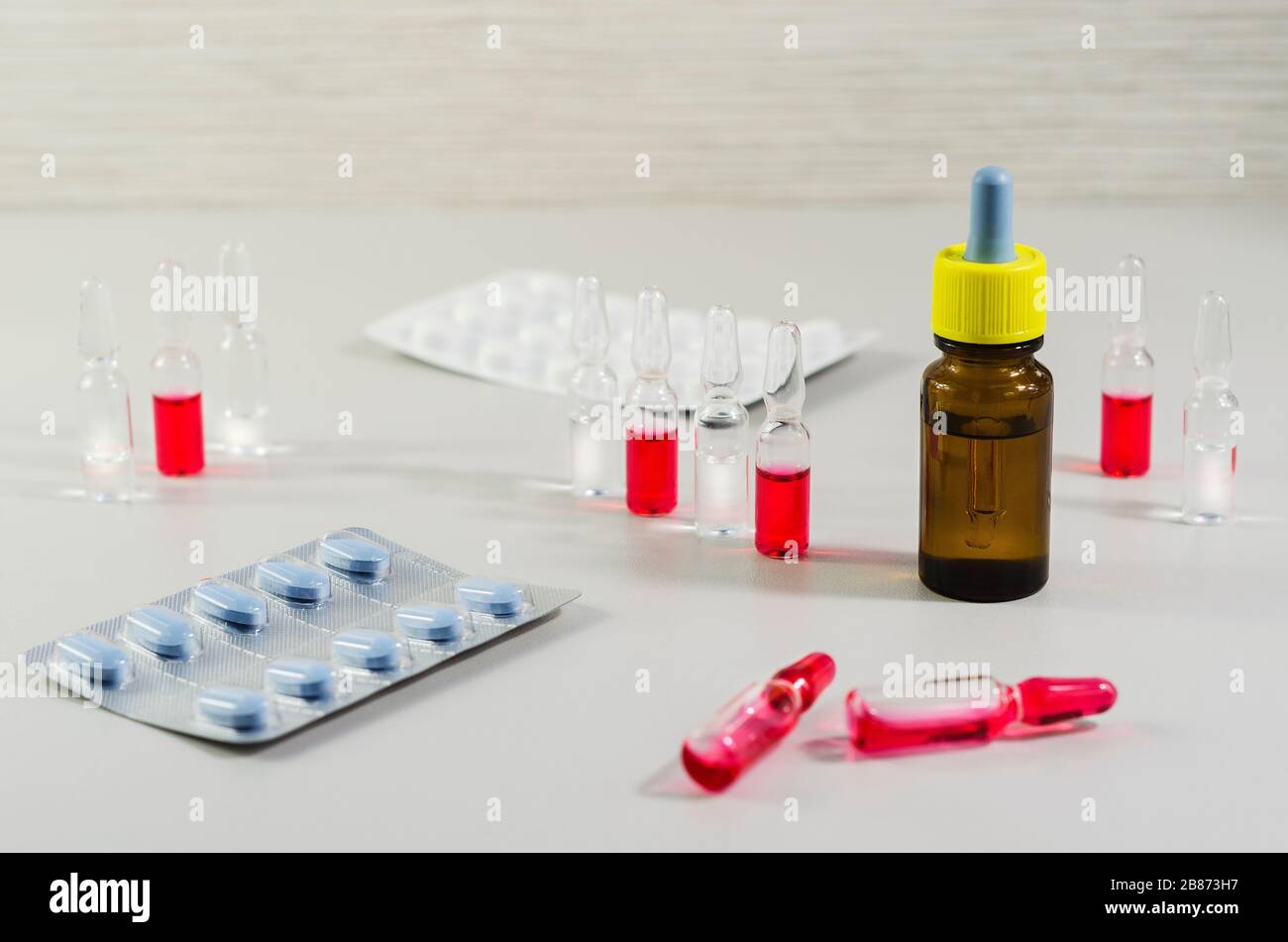 Ampoules with white and red liquid pills on a light background Stock ...